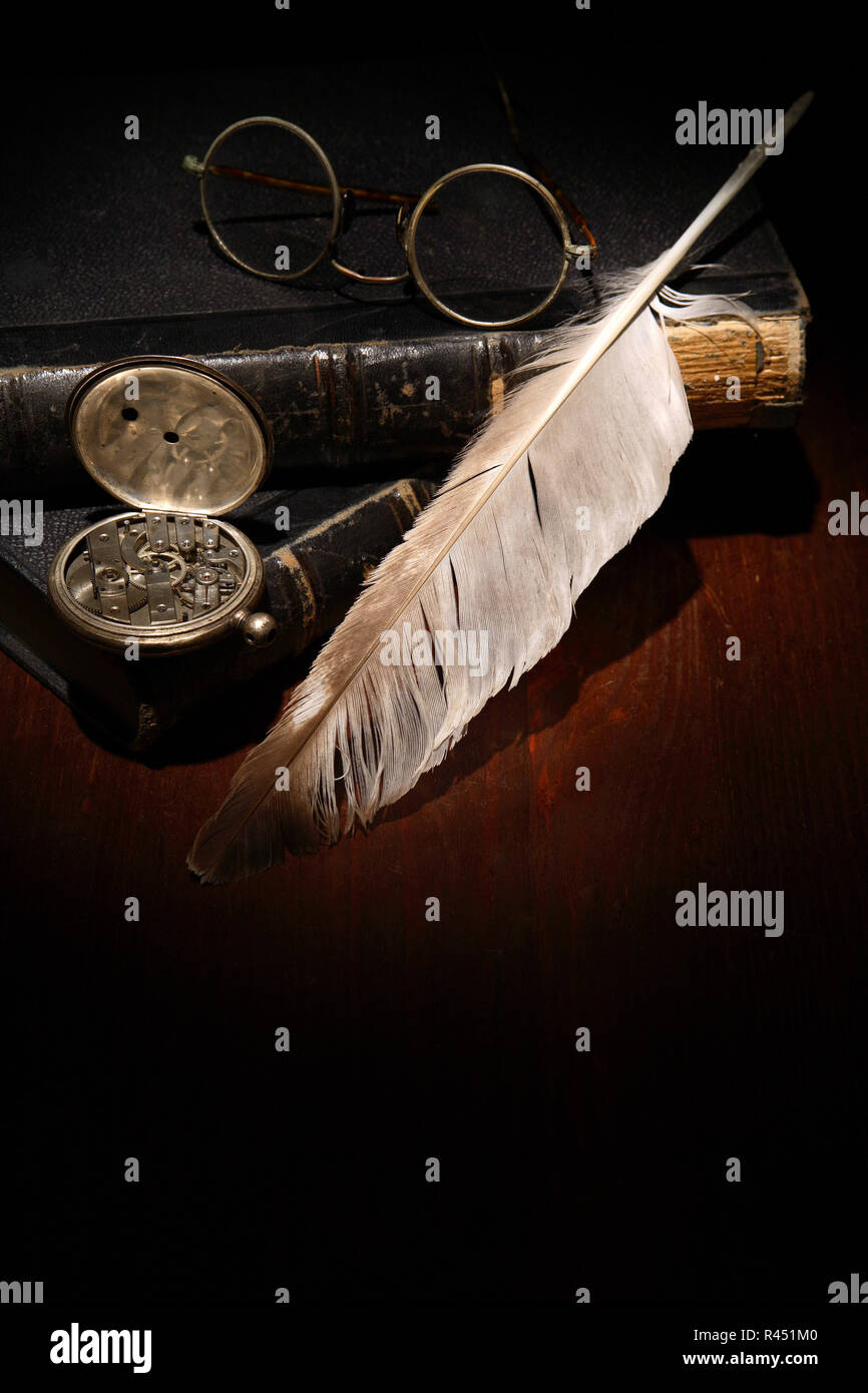 Vintage still life with quill pen and spectacles on old books Stock ...