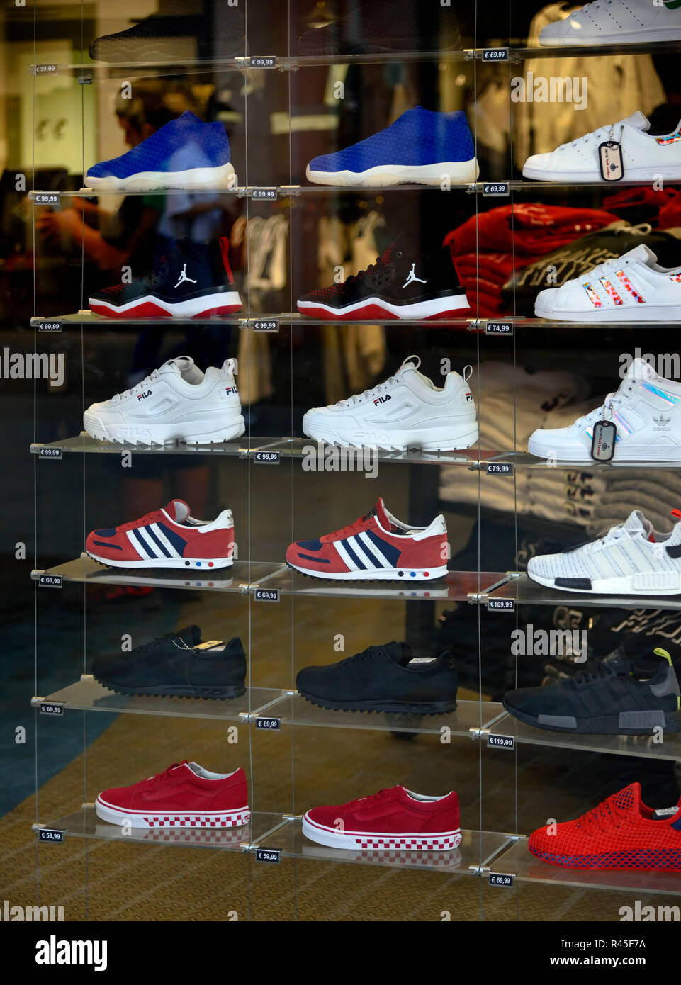 trainers in shop window Stock Photo - Alamy
