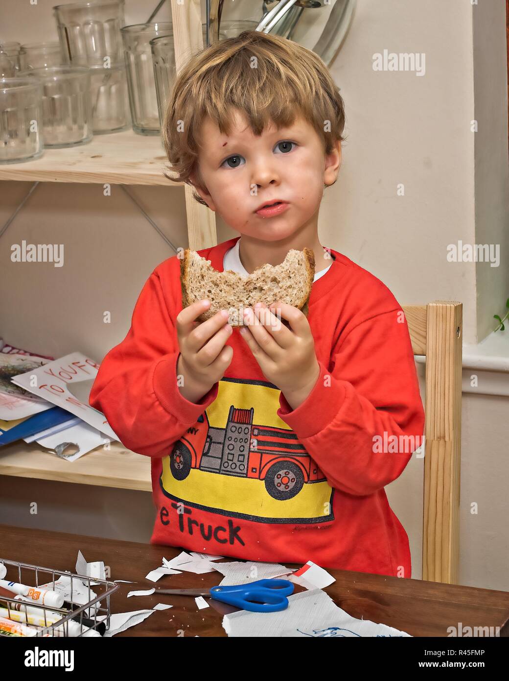 [Young boy eating a sandwich Stock Photo - Alamy