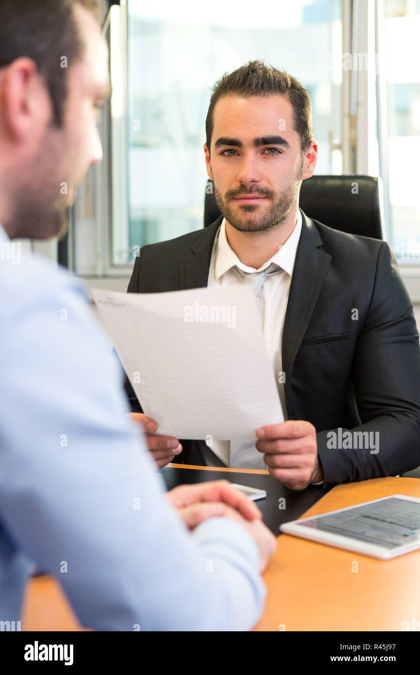 Attractive boss doing interview with his assistant Stock Photo - Alamy