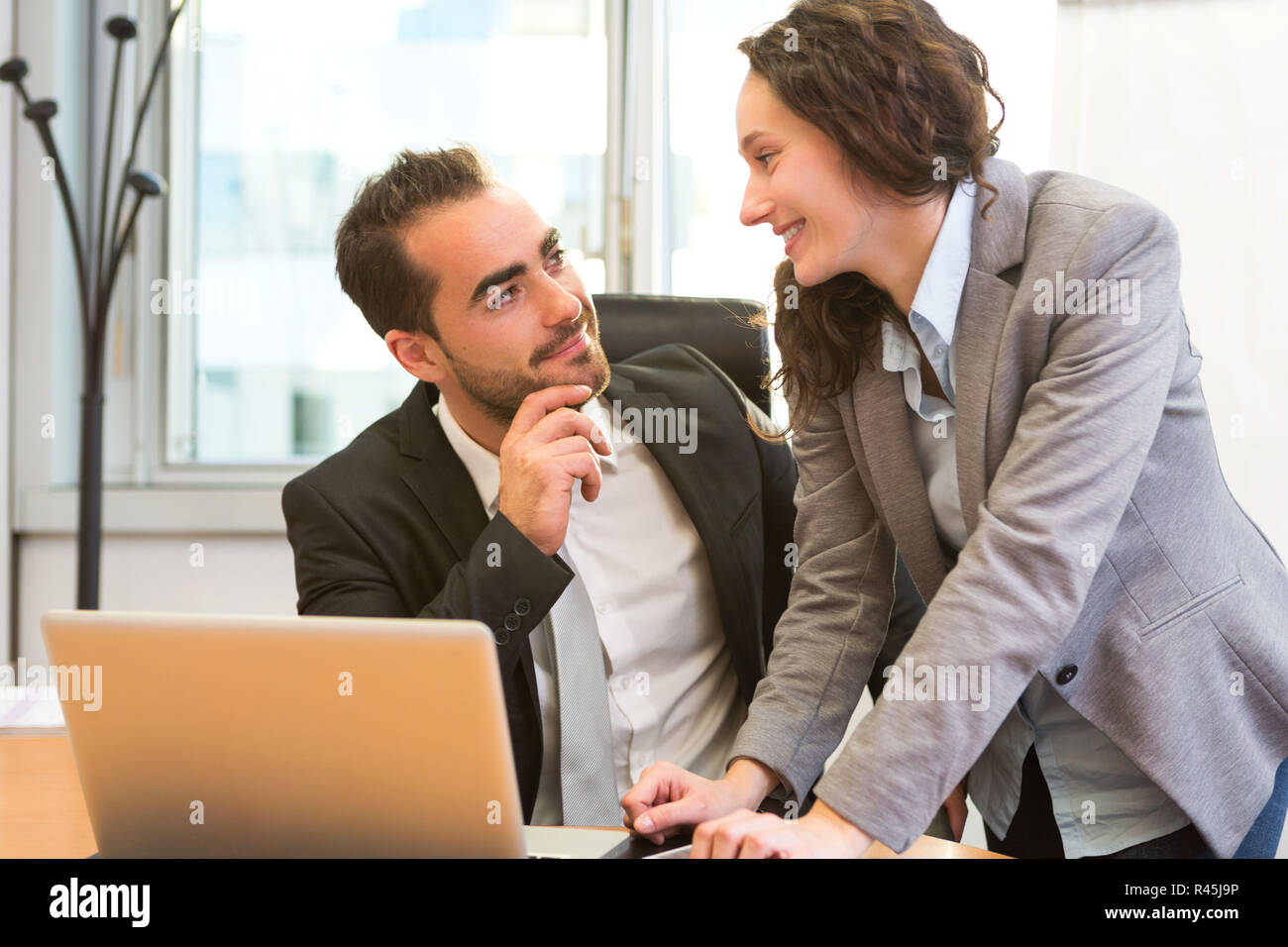 Business man and assistant talking about work Stock Photo - Alamy