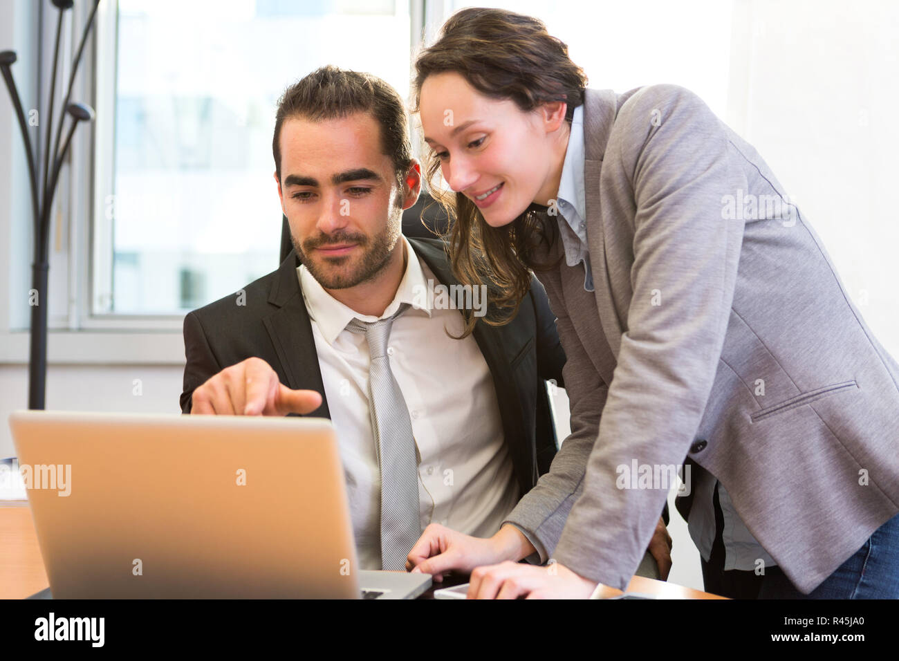 Business man and assistant talking about work Stock Photo - Alamy