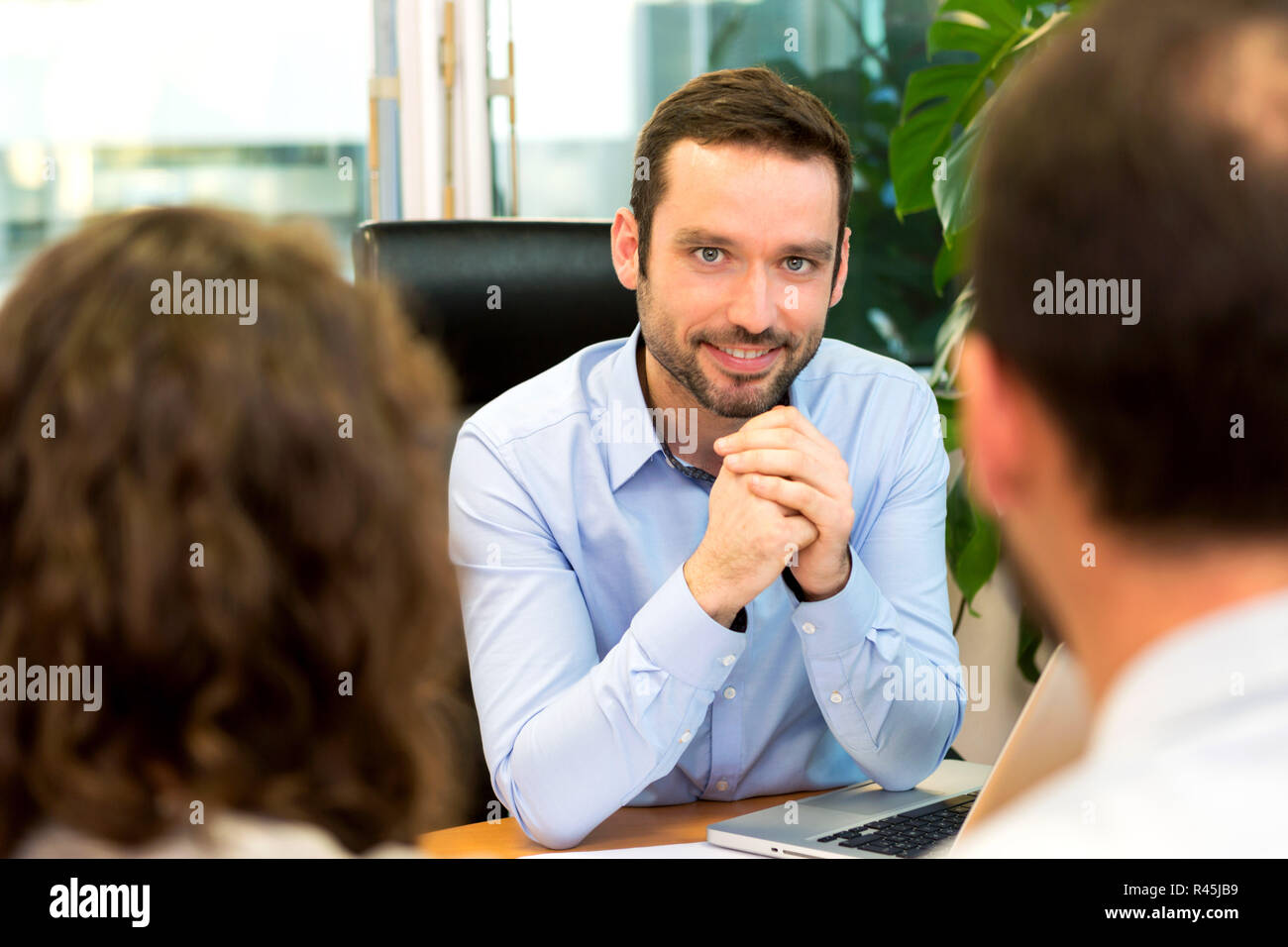 Real estate agent meeting couple at the office Stock Photo - Alamy