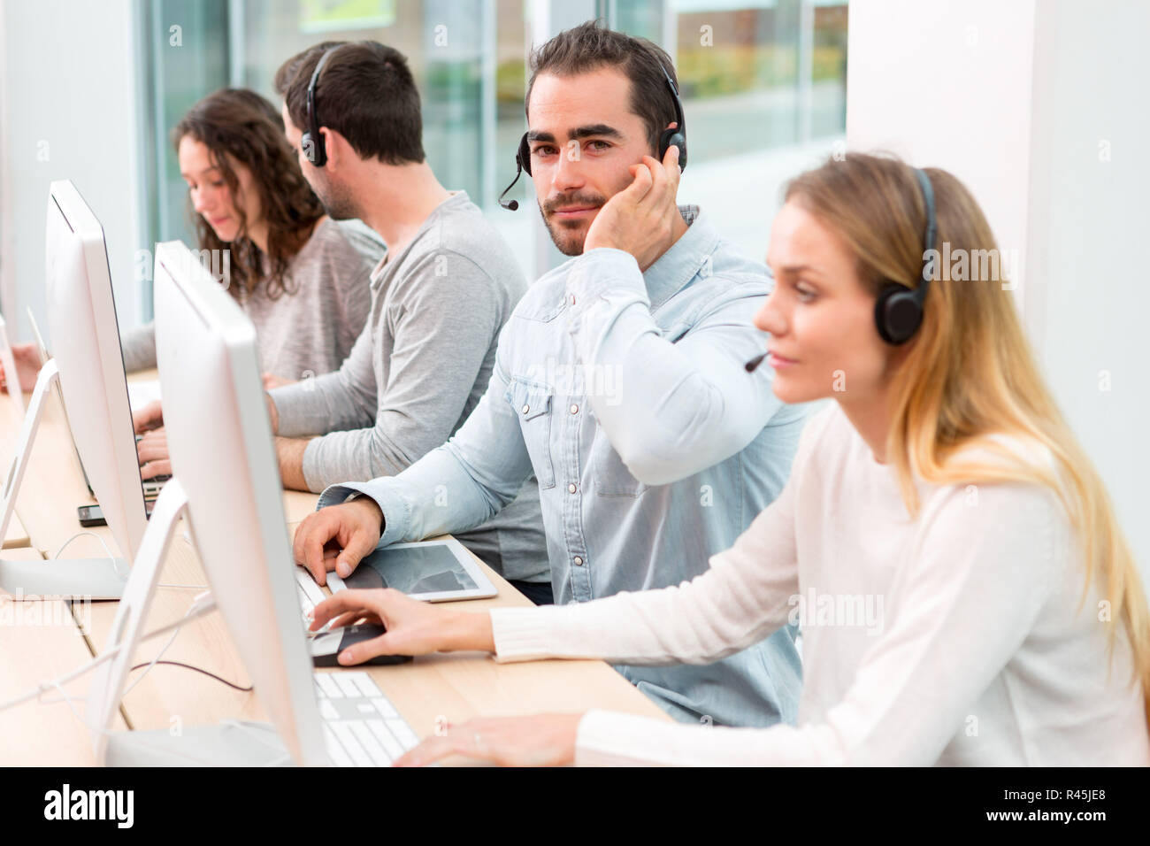Young attractive man working in a call center Stock Photo - Alamy