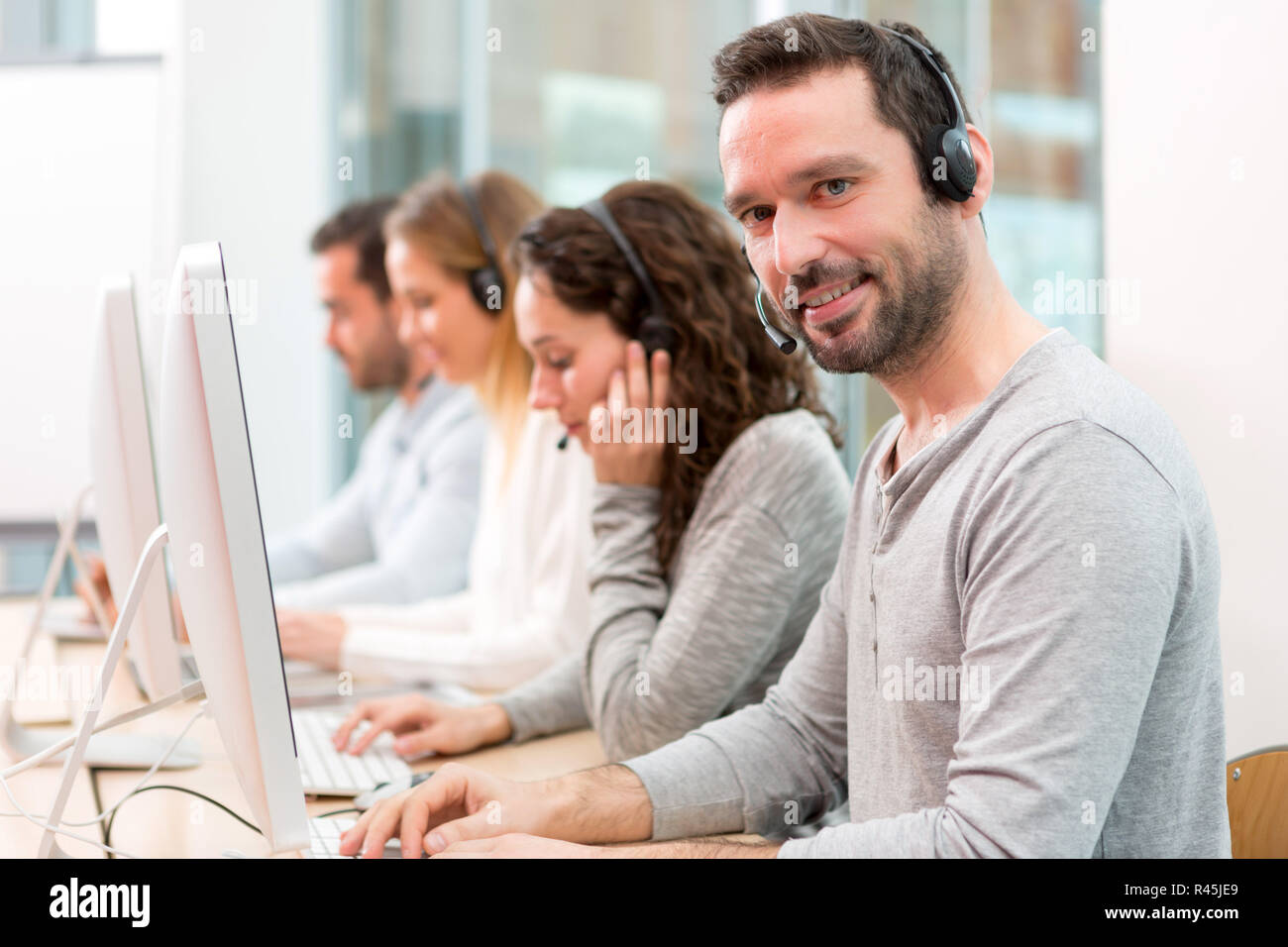 Young attractive man working in a call center Stock Photo - Alamy
