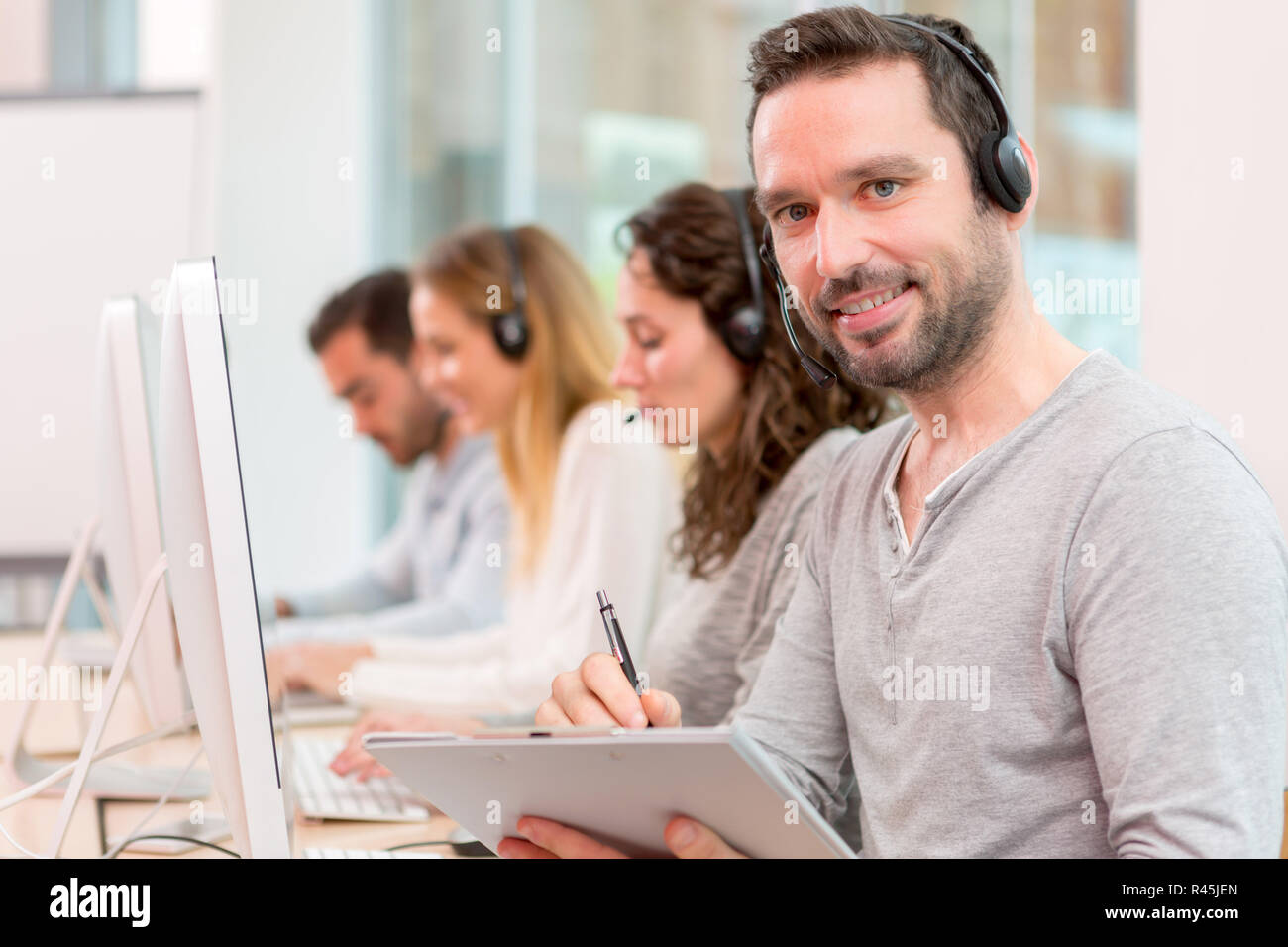 Young attractive man working in a call center Stock Photo - Alamy