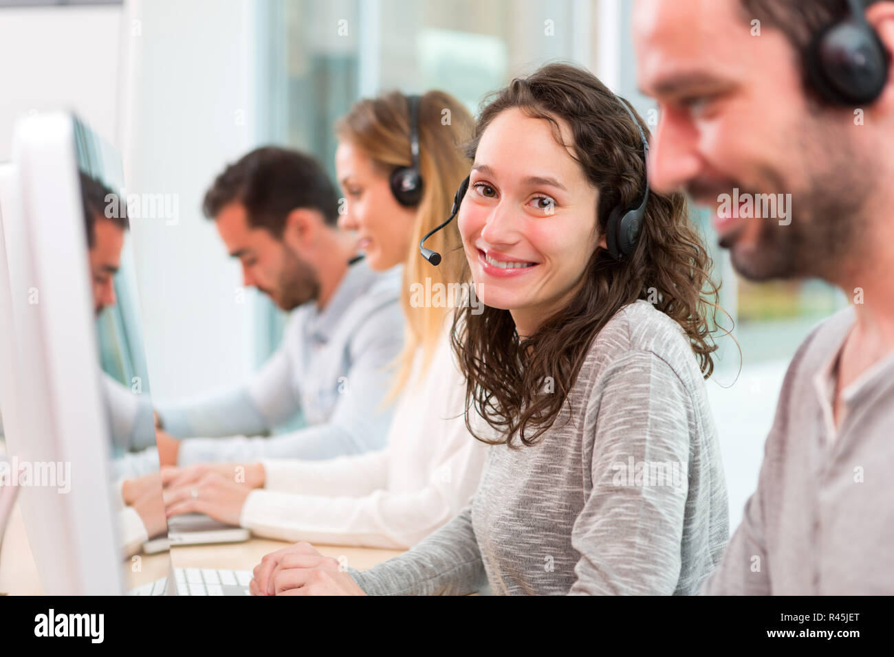 Young attractive woman working in a call center Stock Photo - Alamy