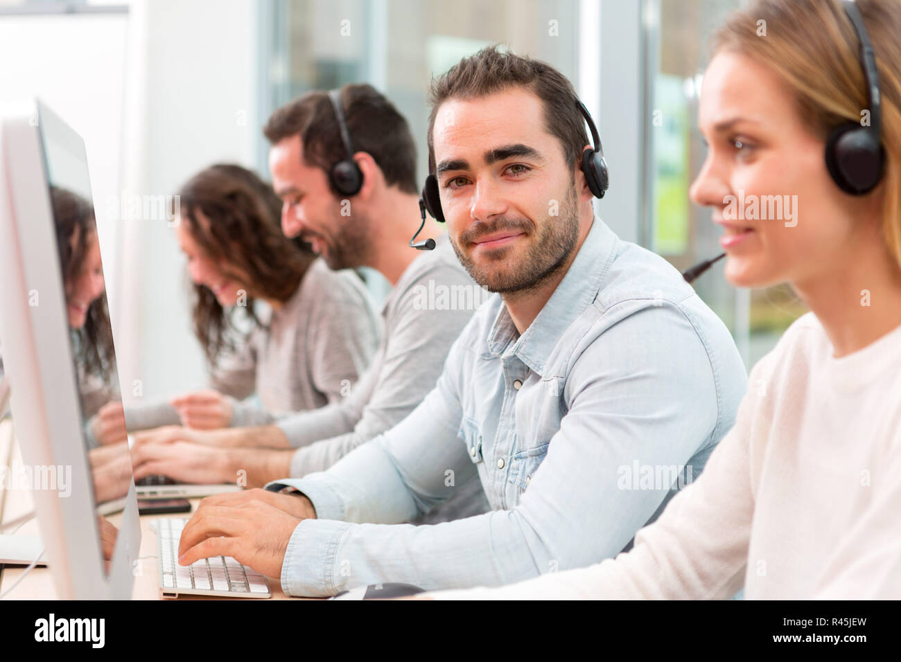 Young attractive man working in a call center Stock Photo - Alamy