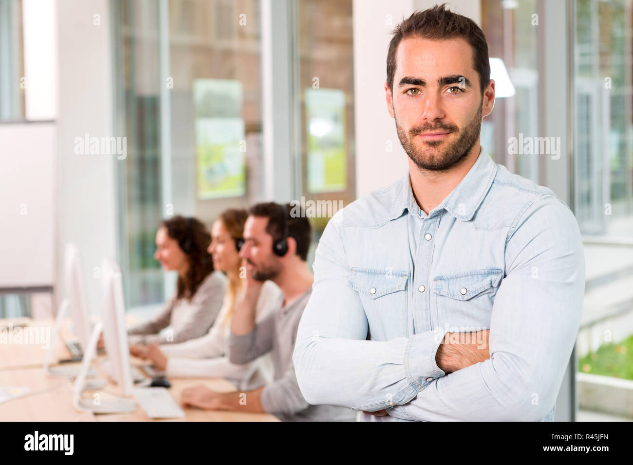 Portrait of a young attractive man at work Stock Photo - Alamy