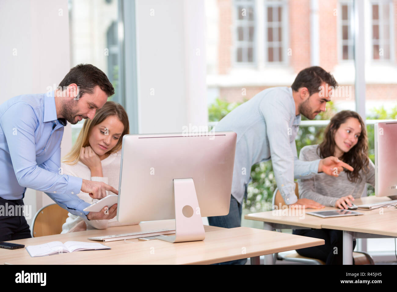 Young attractive people taking a training course with formator Stock ...