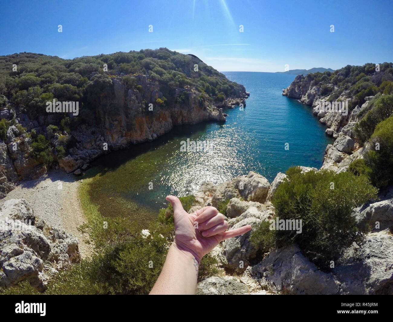 A beautiful cove with a beach and aqua blue water leading out onto the ...