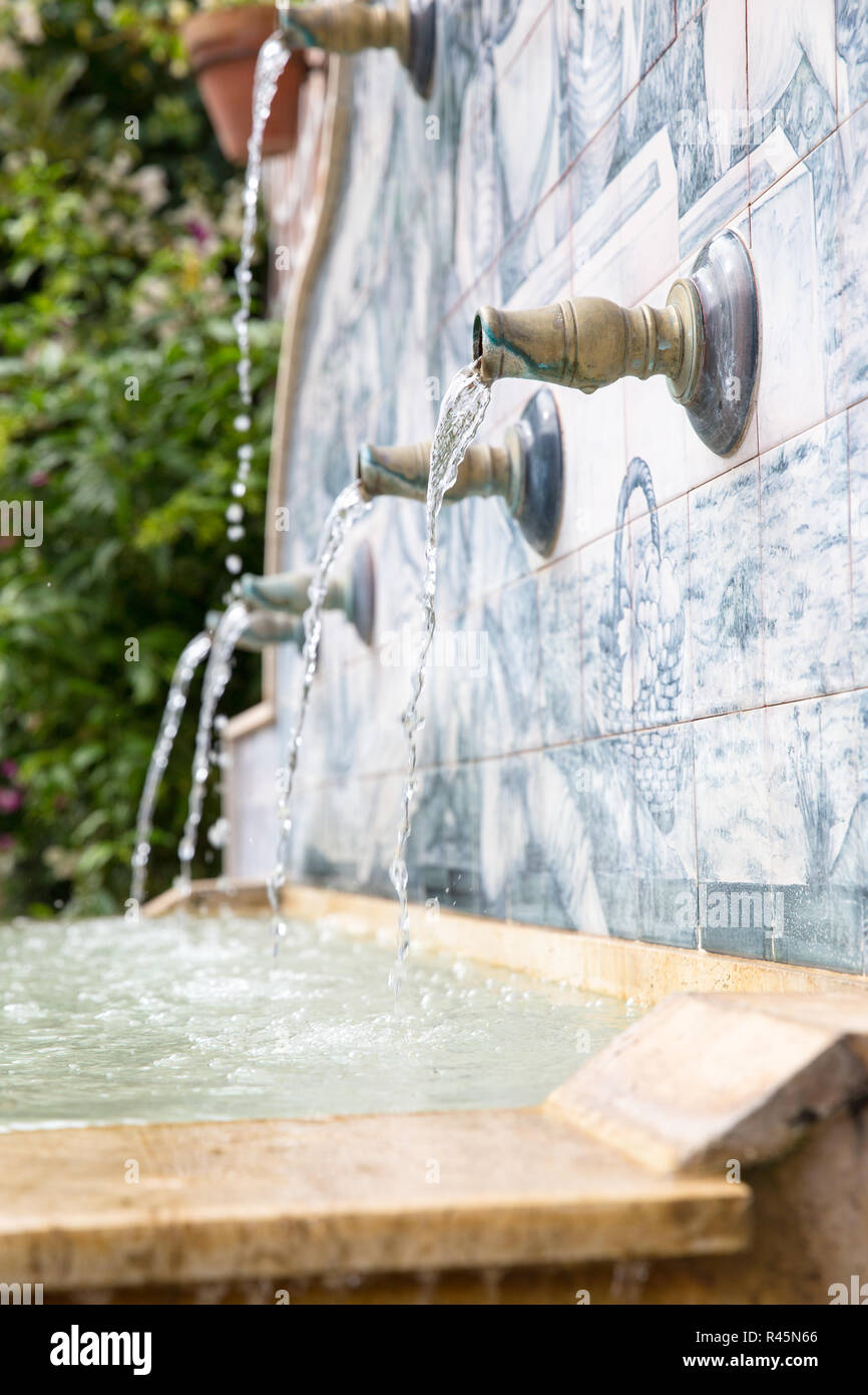 Water coming out of pipes in a fountain Stock Photo - Alamy