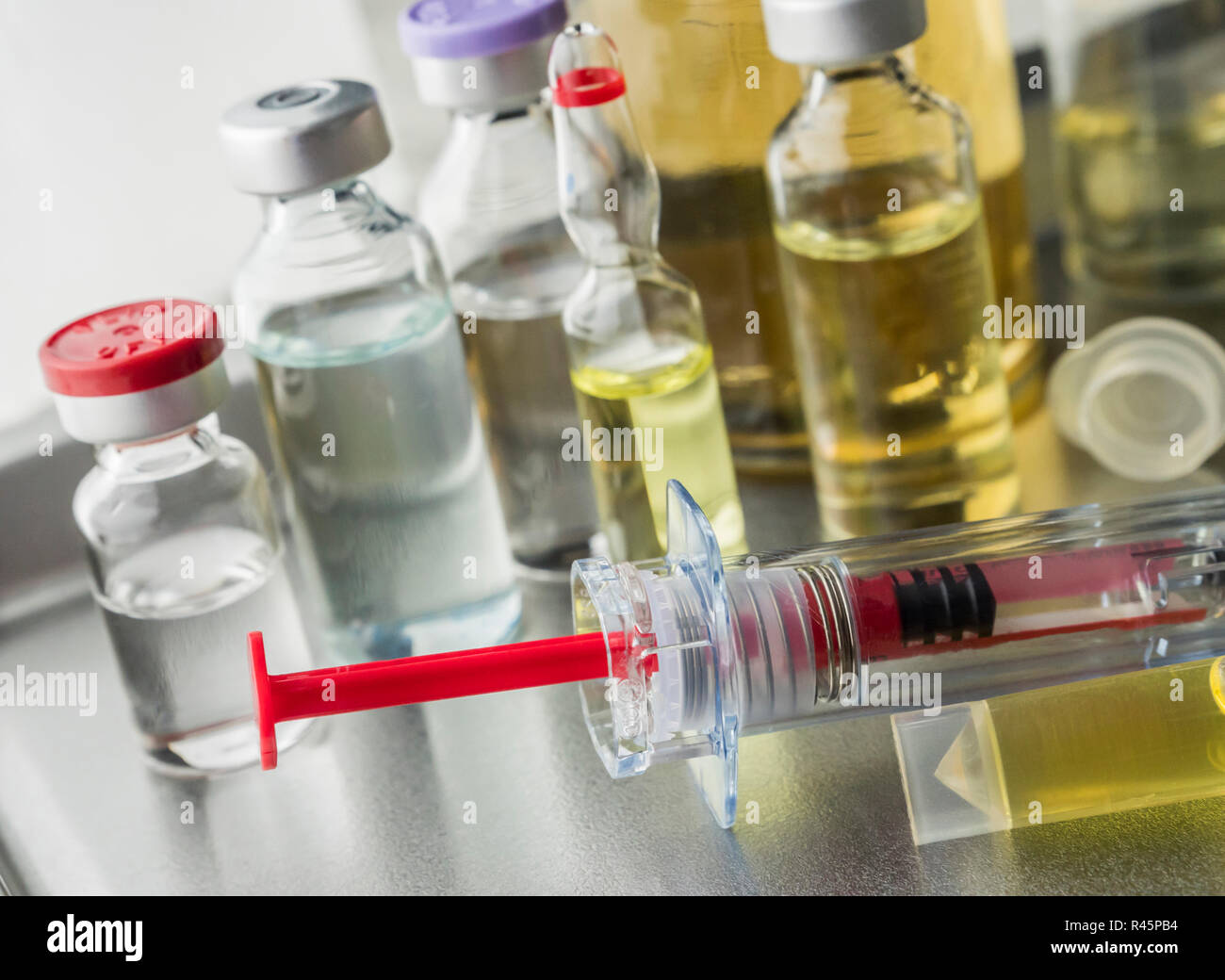 Several syringes and vials in a laboratory in a hospital, conceptual image Stock Photo - Alamy