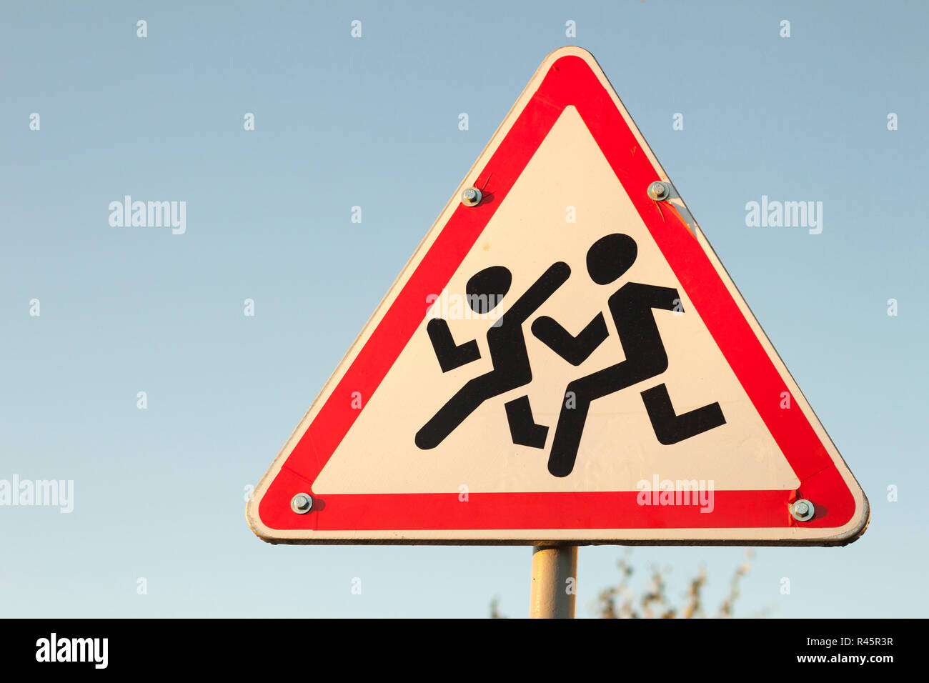 Information road sign, triangular white shield with running children ...
