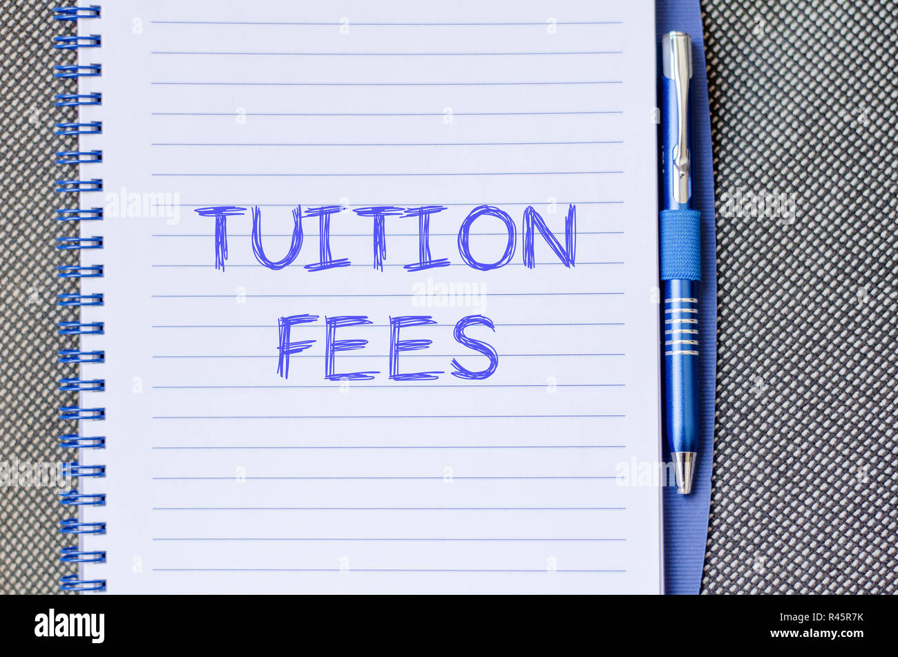 Tuition fees write on notebook Stock Photo - Alamy
