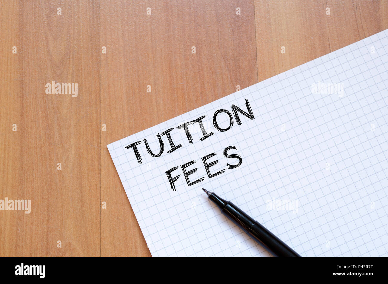 Tuition fees write on notebook Stock Photo - Alamy