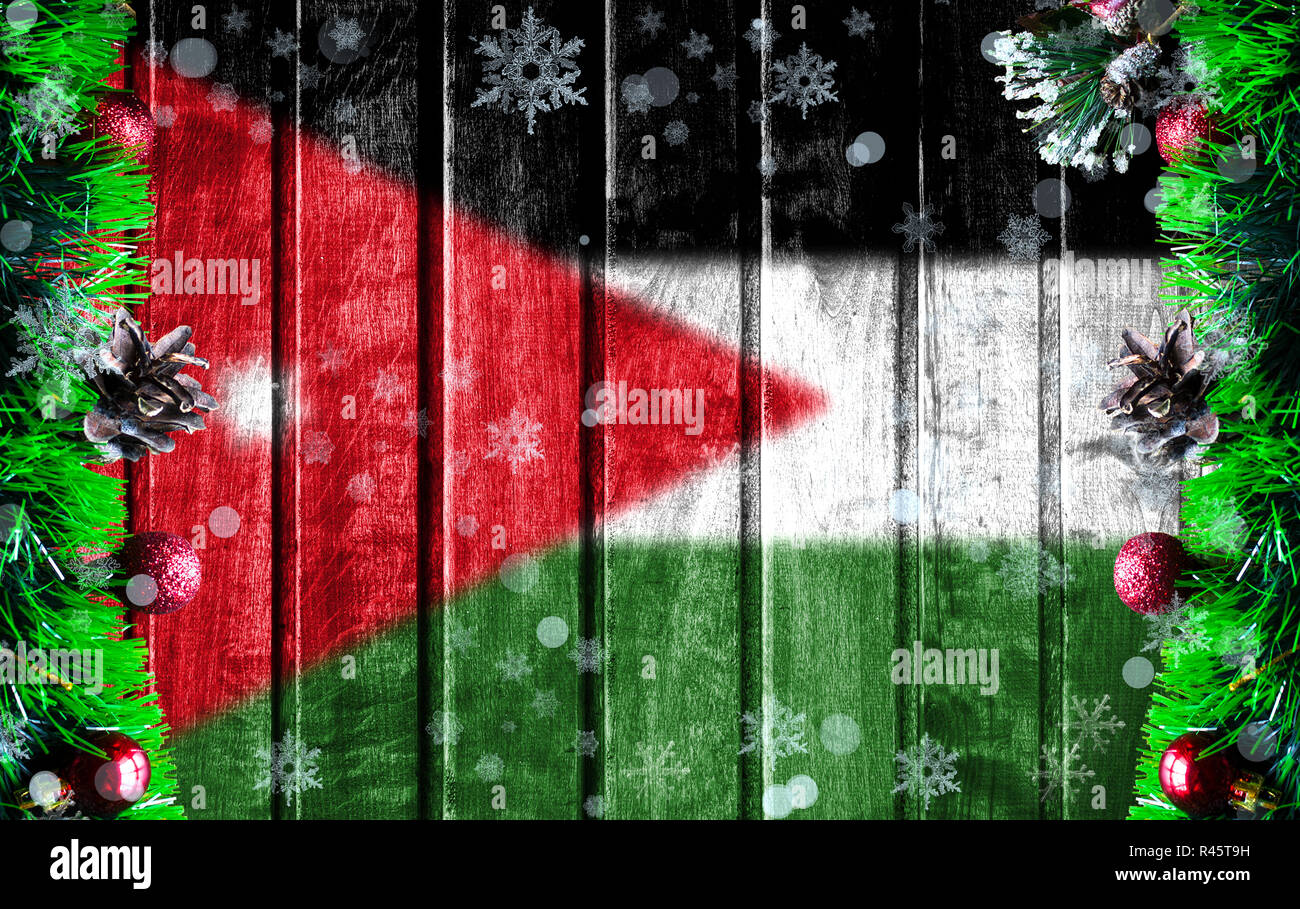 Wooden Christmas background with blurred flag of Jordan. There is a ...