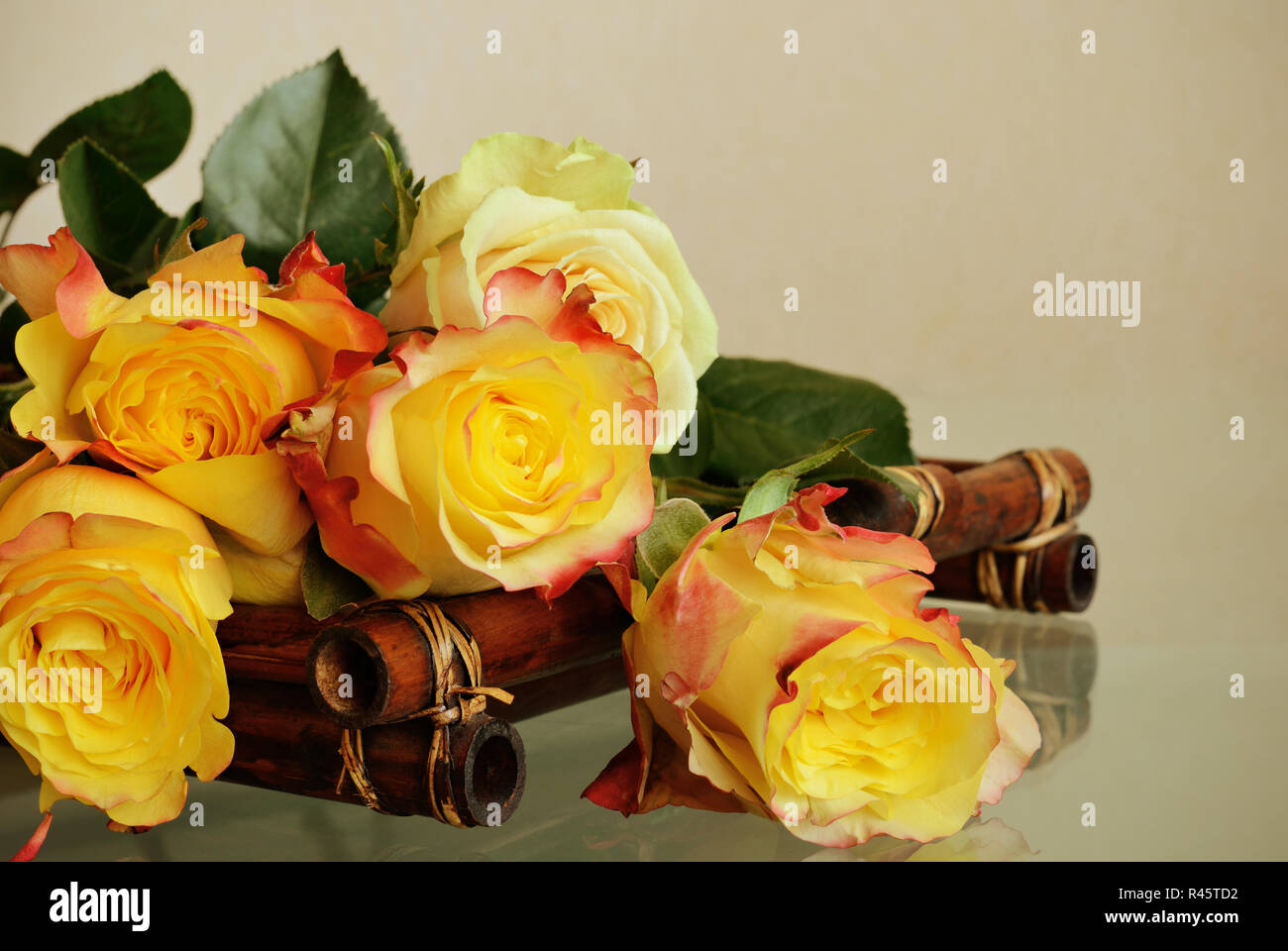 Yellow roses on a glass table Stock Photo - Alamy