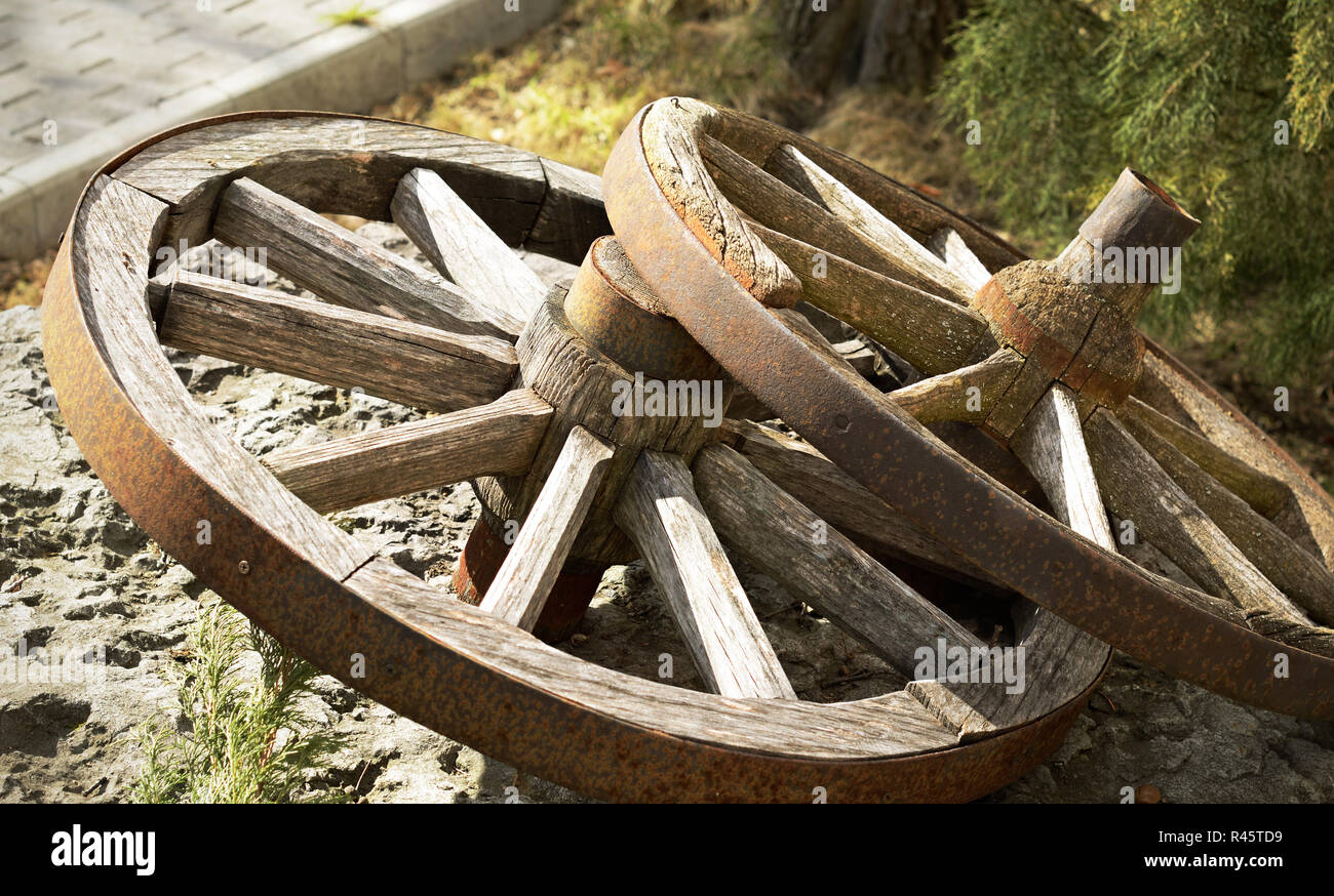 A pair of wooden wheels on the ground Stock Photo - Alamy