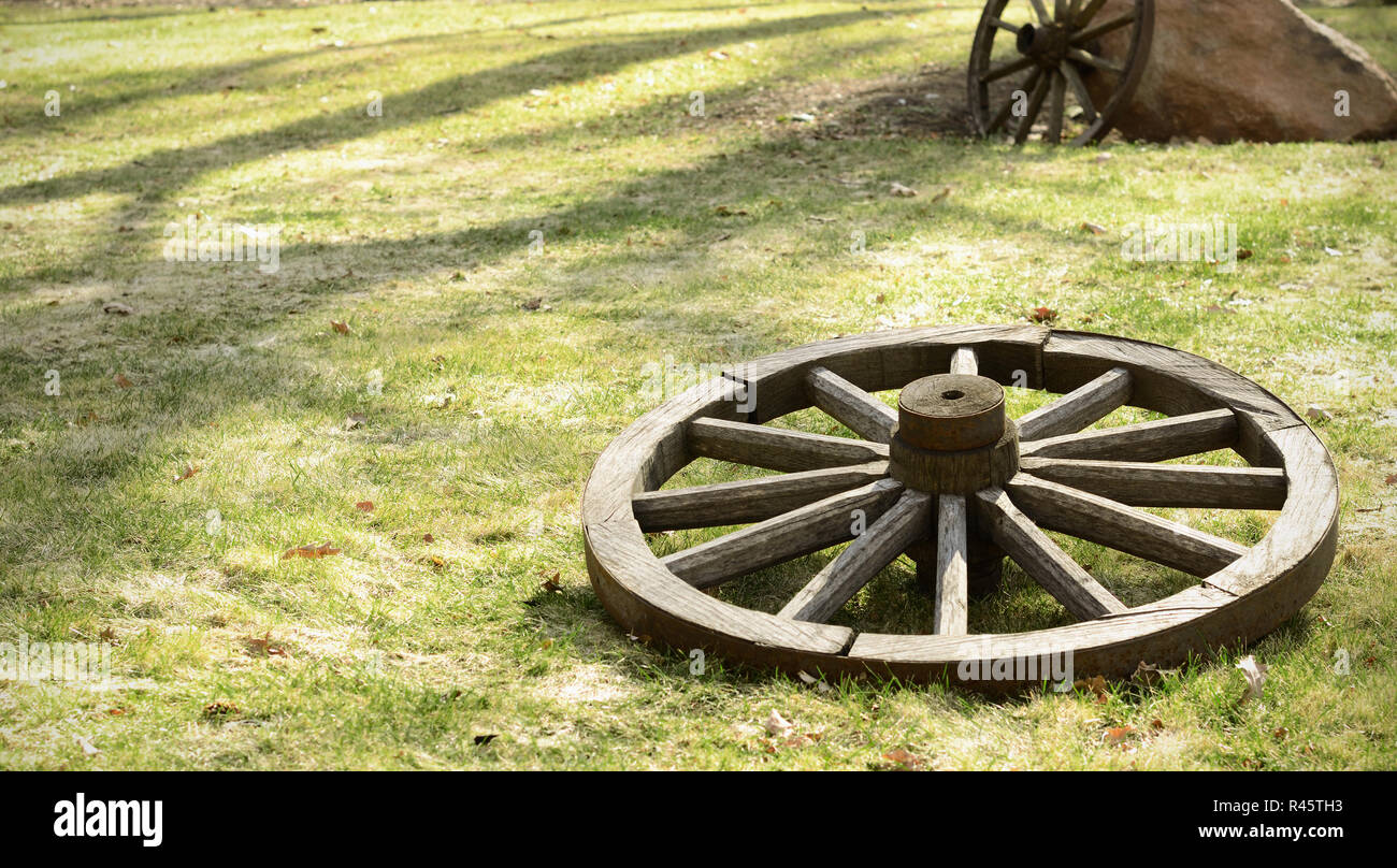 Old wooden wheel is on the ground Stock Photo - Alamy