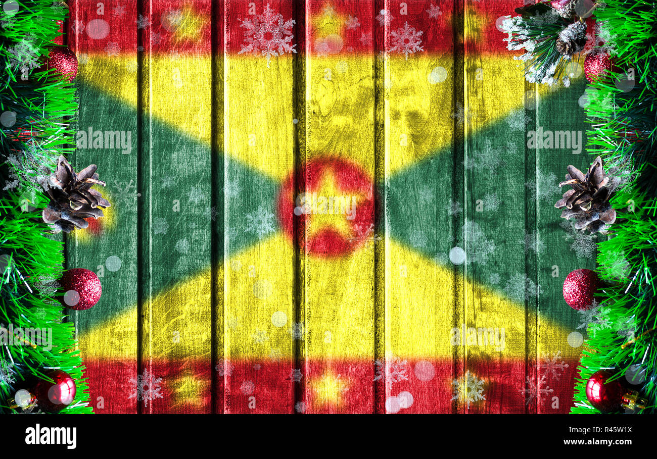 Wooden Christmas background with blurred flag of Grenada. There is a ...