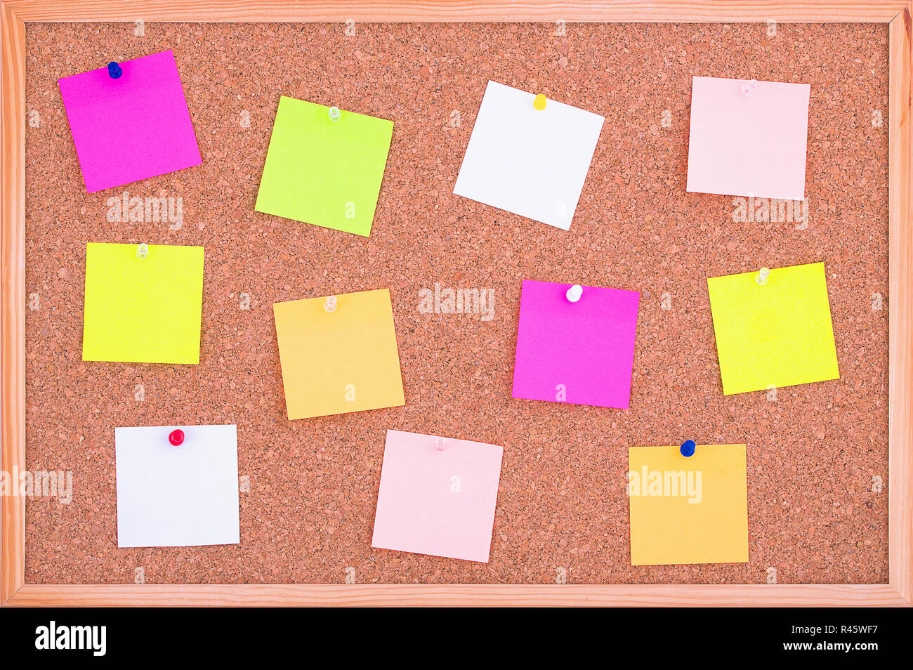 Cork board wood background with post it notes in different radiant ...