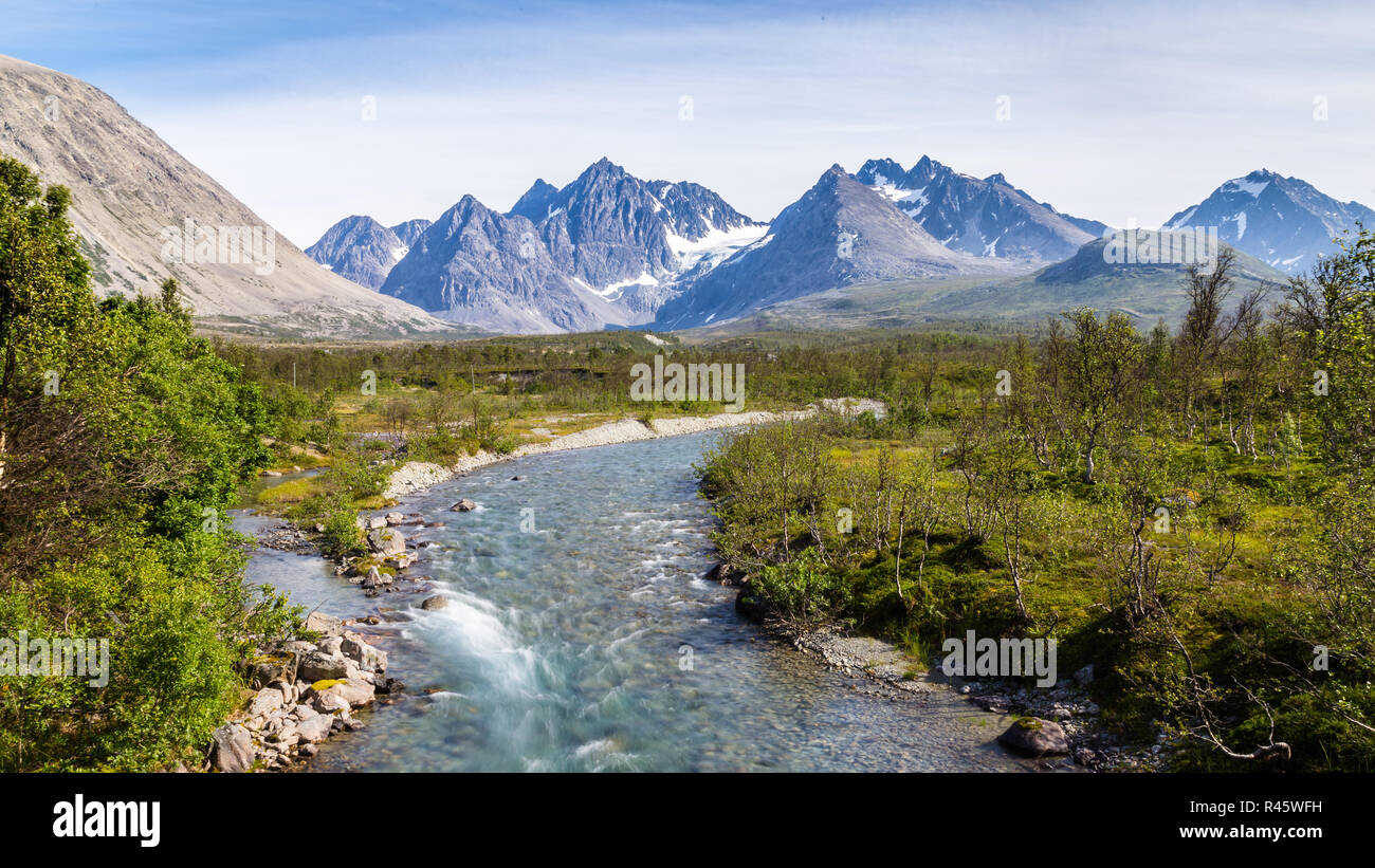 Scandinavian landscape with rapids in a river and a glacier in the ...