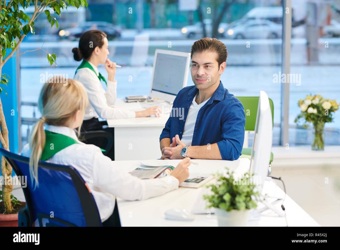 Young man listening to bank manager Stock Photo - Alamy