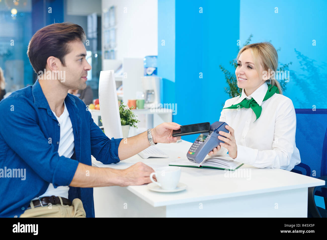 Young adult paying in bank hi-res stock photography and images - Alamy