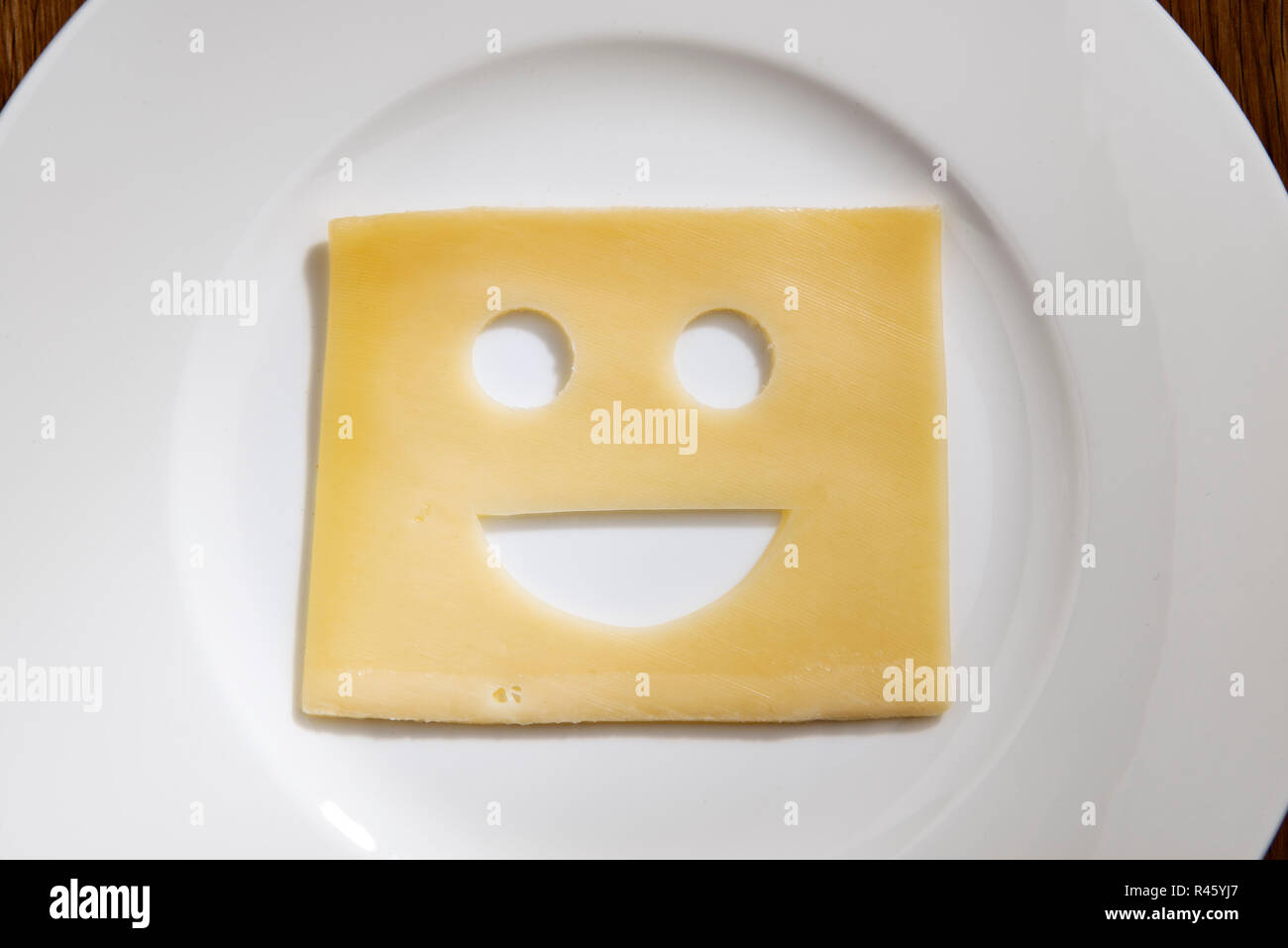Cheese with smiling face on a table Stock Photo - Alamy