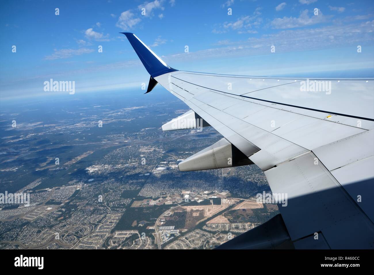 View of wing, clouds and earth below from an Delta Airlines airplane ...