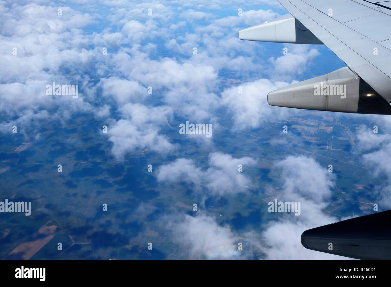 View of wing, clouds and earth below from an Delta Airlines airplane ...