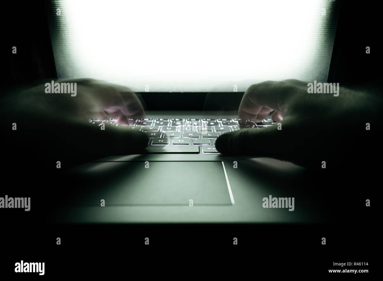 Hacker using laptop. Lots of digits on the computer screen Stock Photo ...