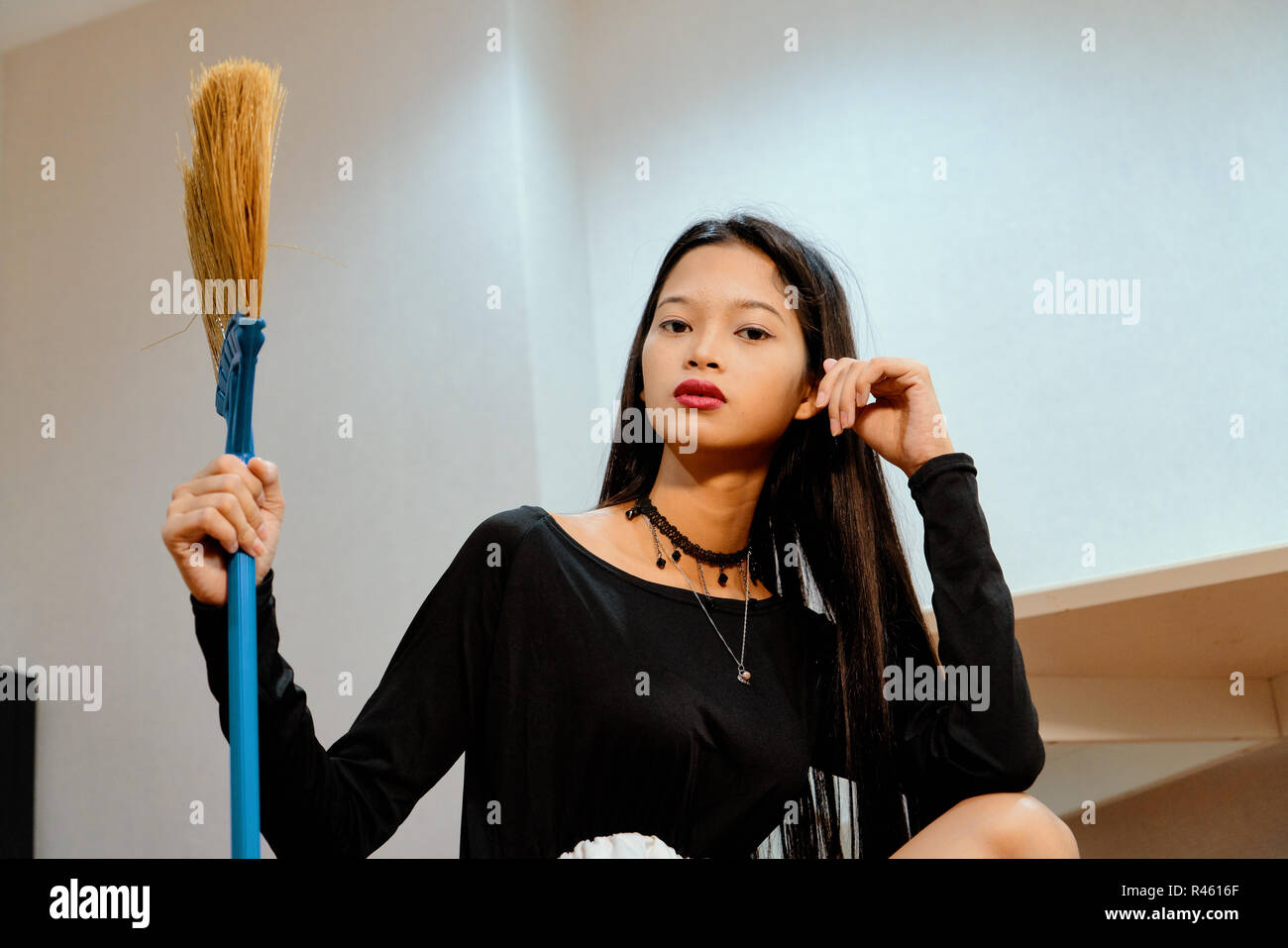 Beautiful woman posing - sitting, hands on head, thinking, sad ...