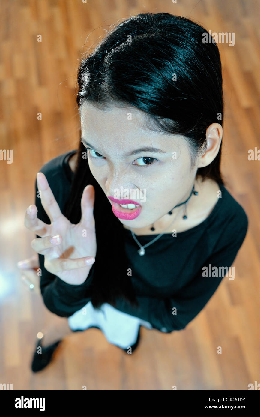 Beautiful woman posing - look up, facial expression, angry, frustrated ...