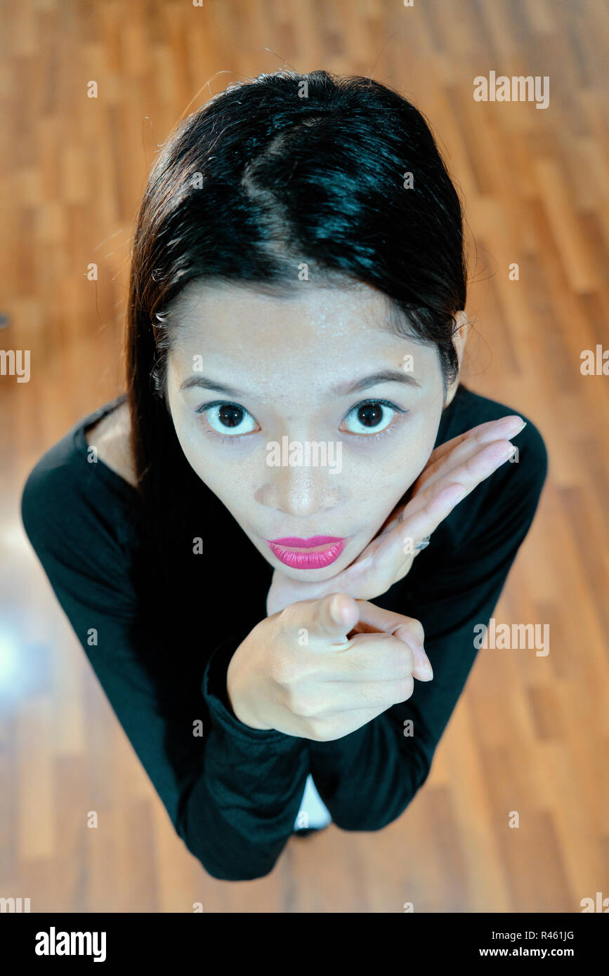 Beautiful woman posing - look up, facial expression, pointing, hand on ...