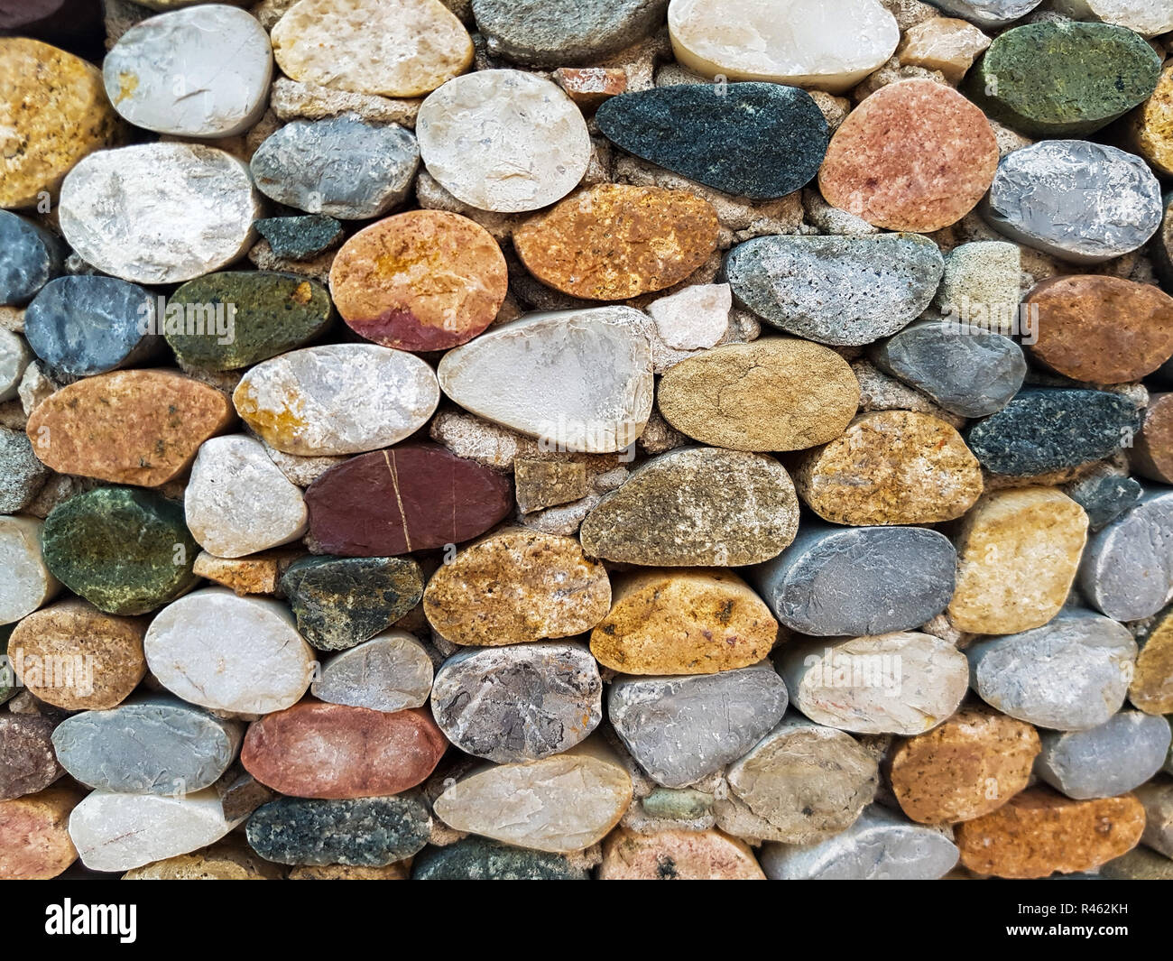 Detail of the colorful round stones wall backdrop Stock Photo - Alamy