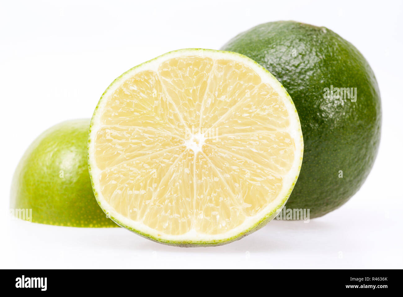pieces of fresh green fruit of lime on white background Stock Photo - Alamy