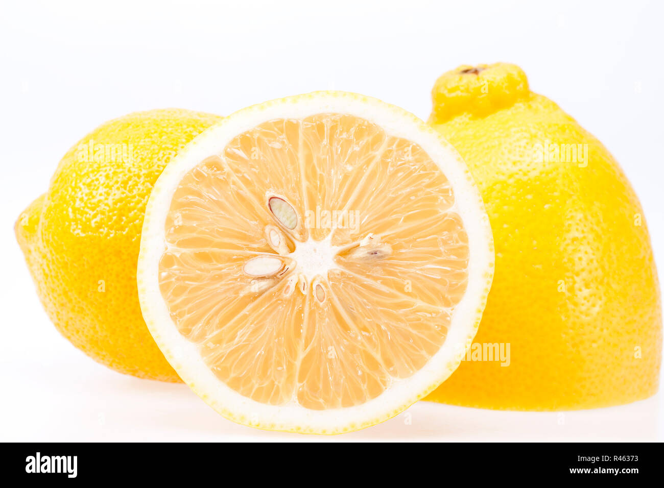 pieces of fresh yellow fruit of lemon on white background Stock Photo ...