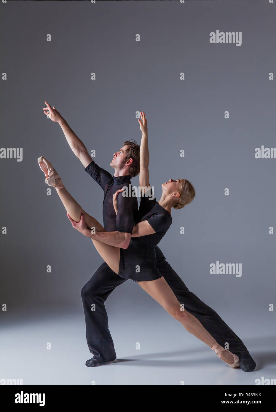 two young modern ballet dancers on gray studio background Stock Photo ...