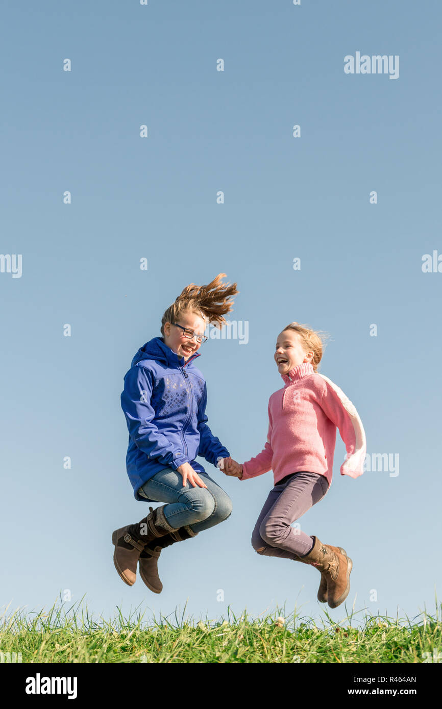 Joyful family two children jumping hi-res stock photography and images ...