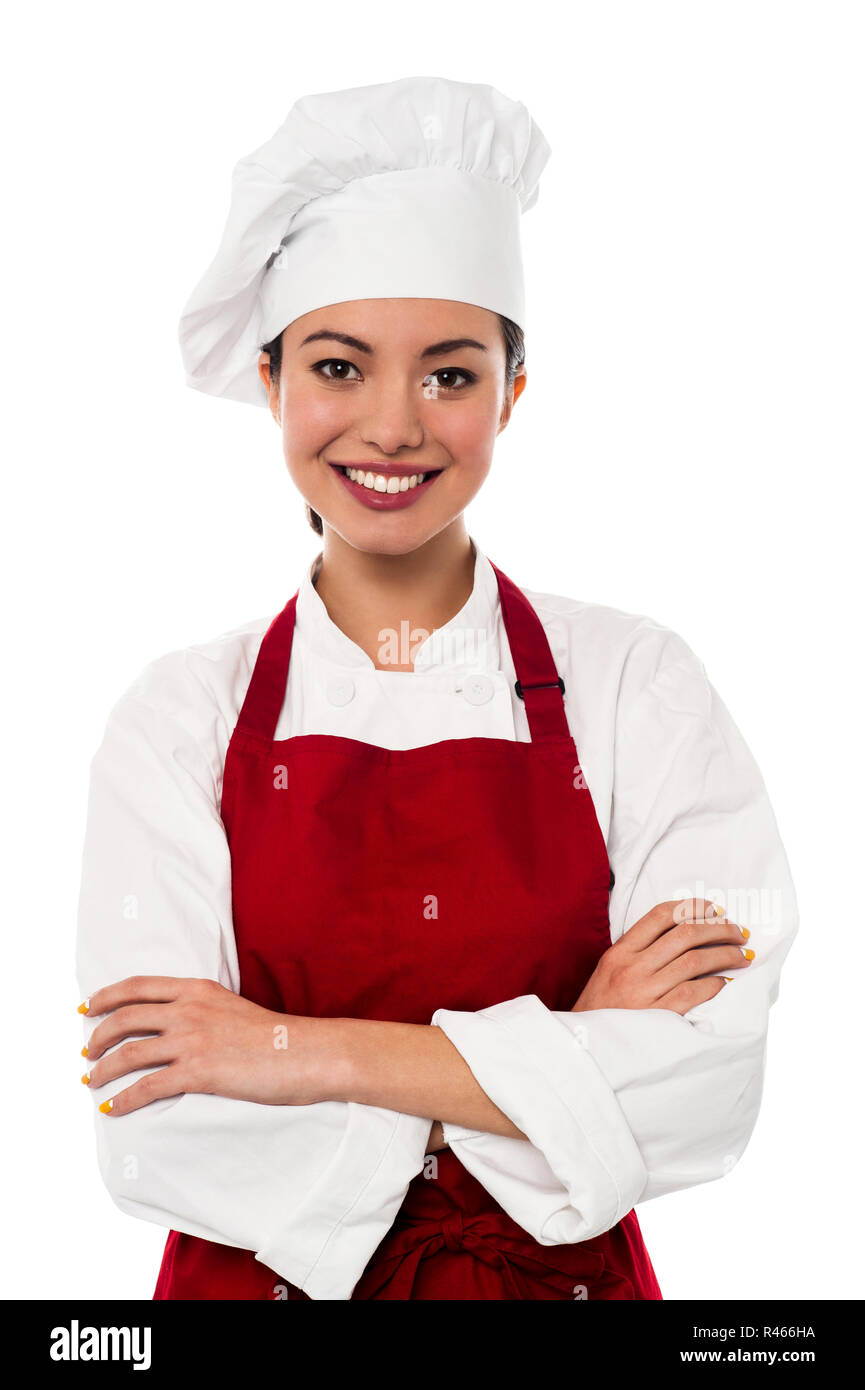 Pretty chef posing with folded arms Stock Photo - Alamy