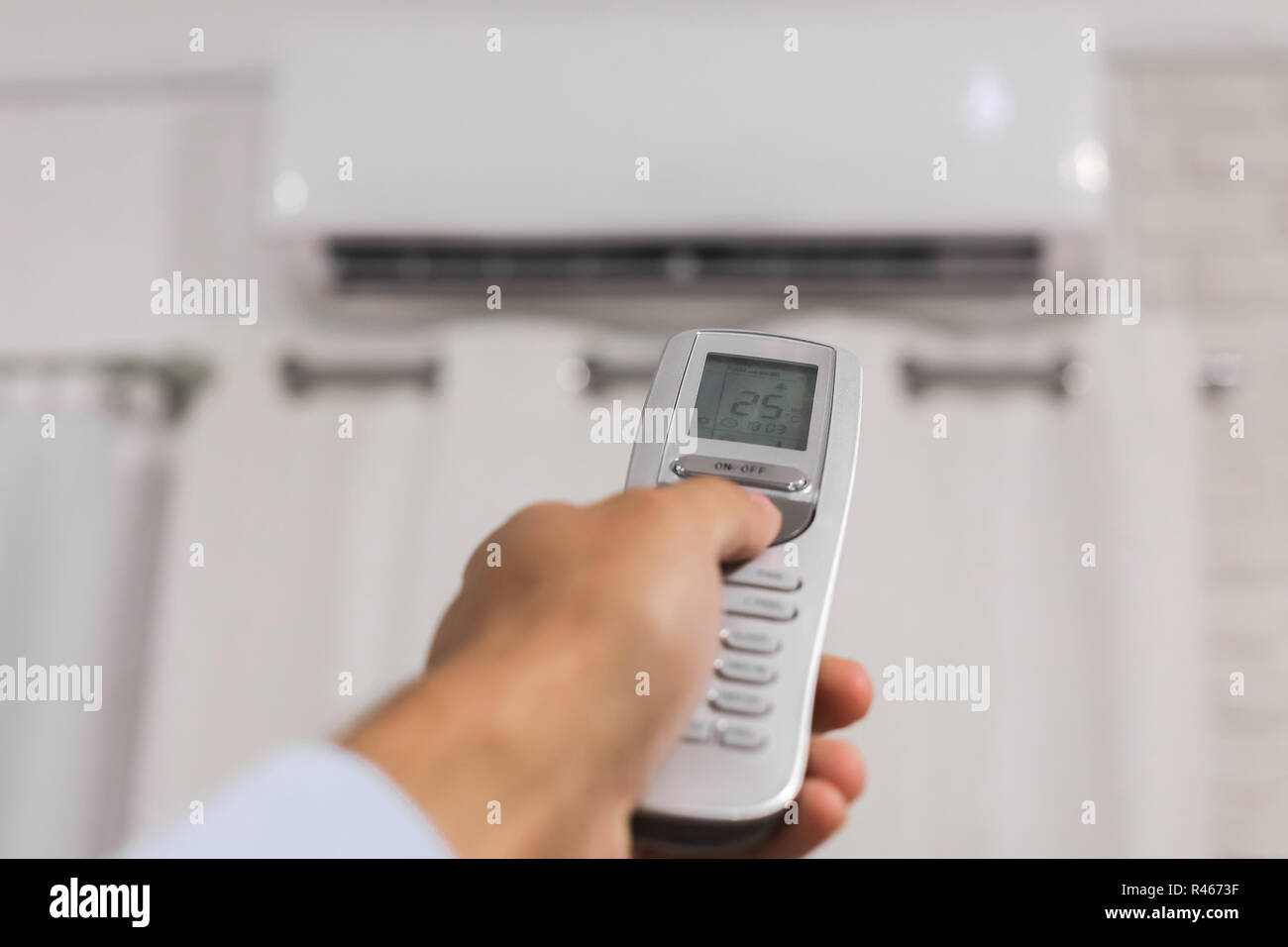 Hand remote air conditioner hi-res stock photography and images - Alamy