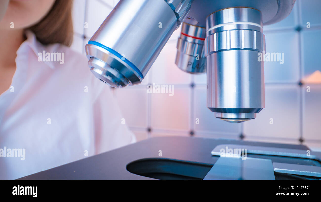 Laboratory technician examining biopsy slide hi-res stock photography ...