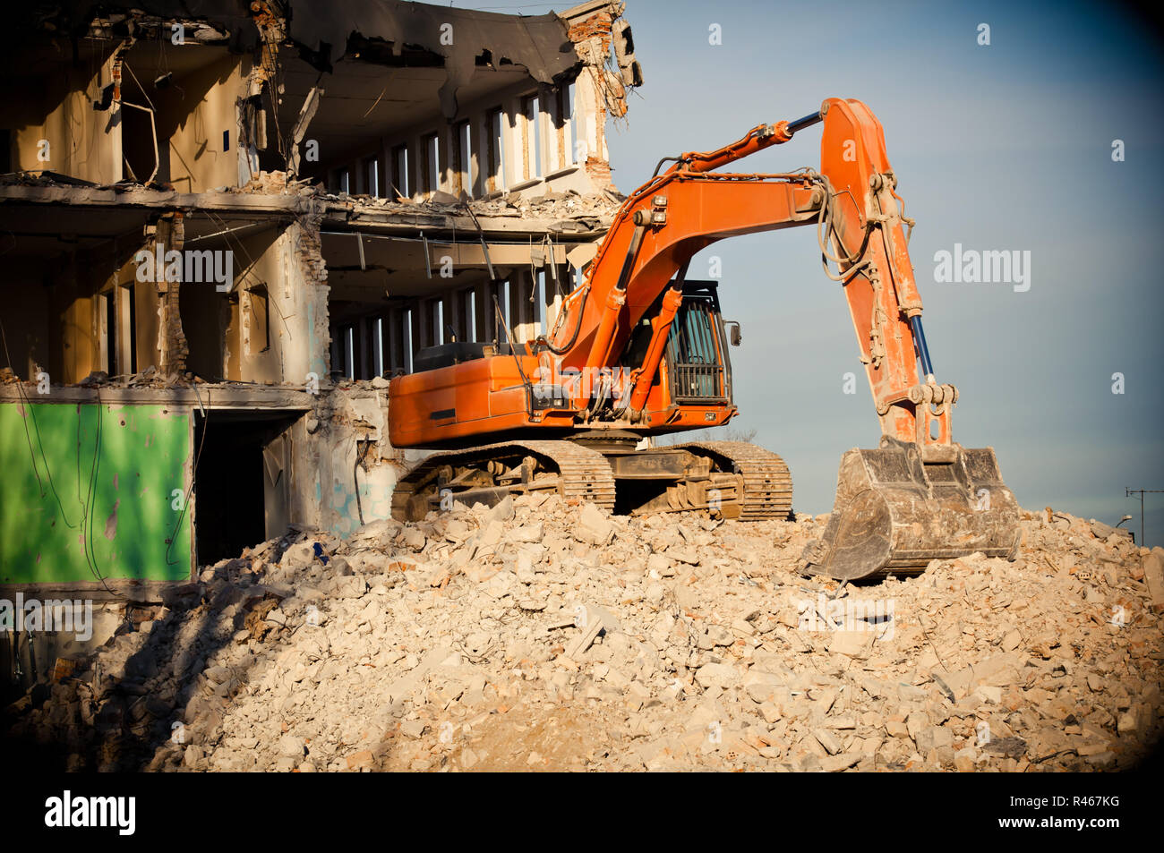 orange big digger destroys building Stock Photo - Alamy
