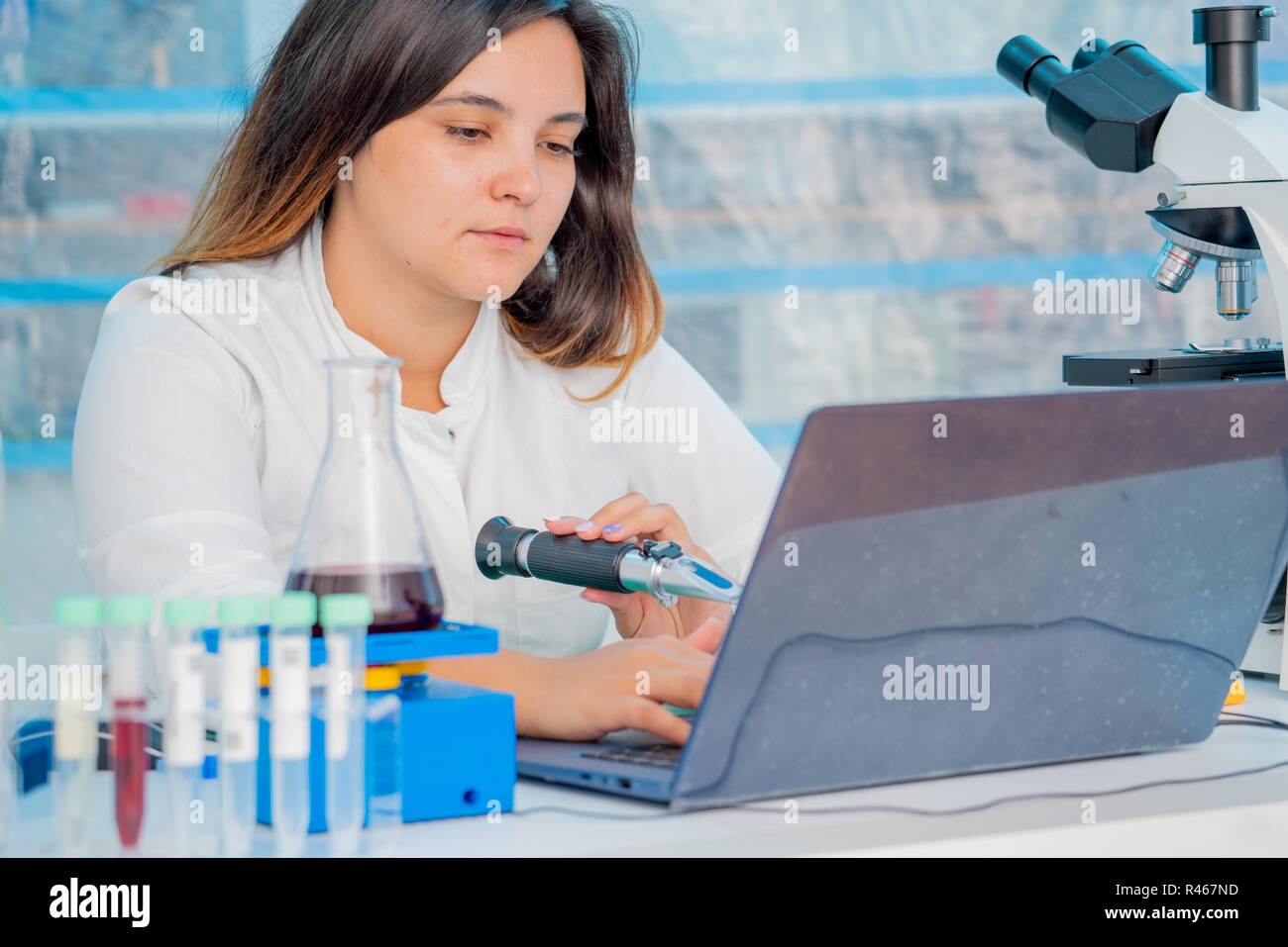 Young female technician in the quality control laboratory use ...