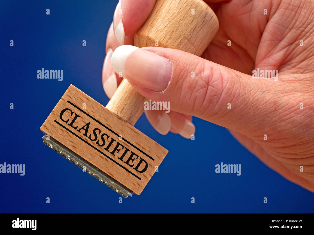 classified - stamp with female hand Stock Photo - Alamy
