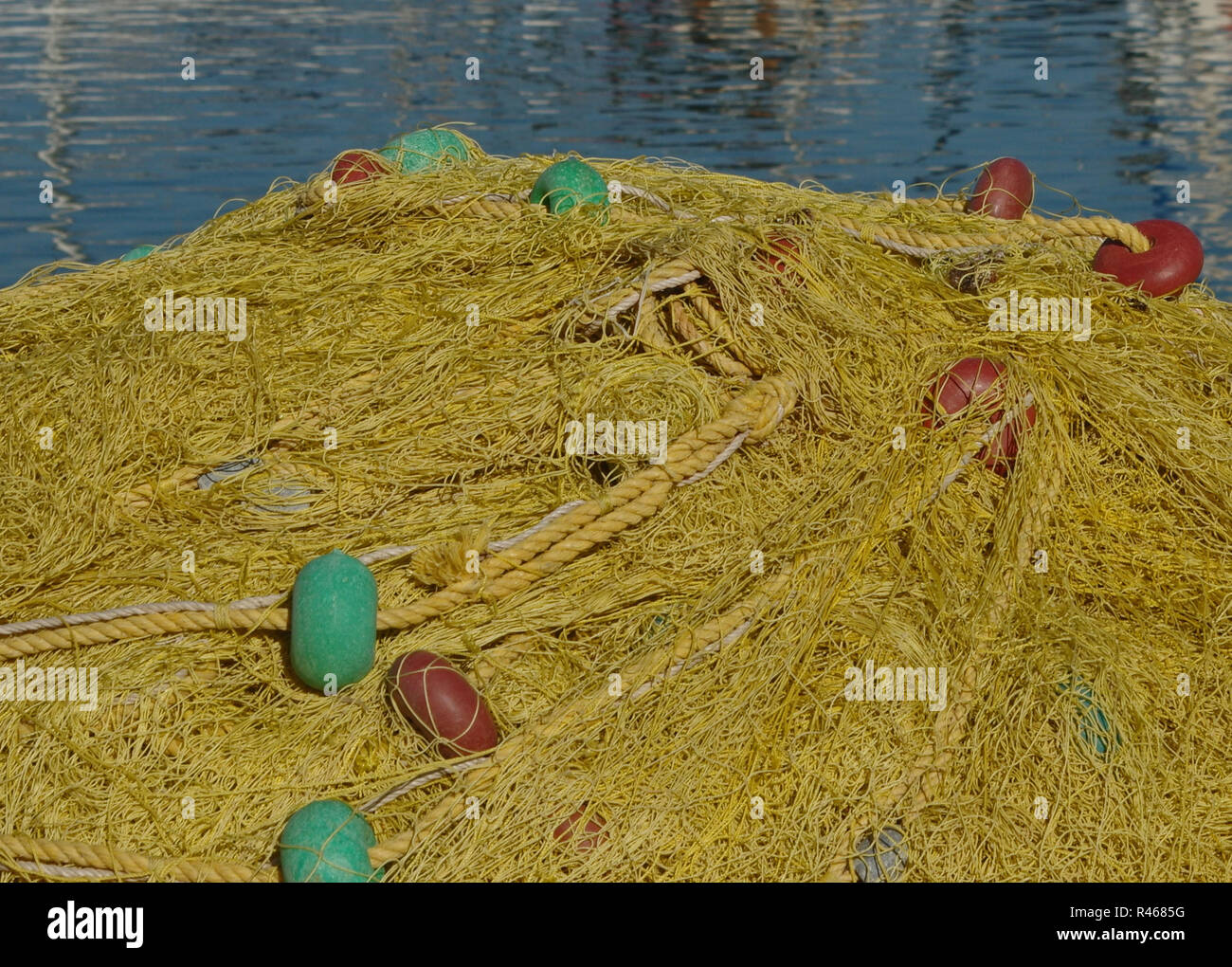 stacked bright yellow fishing nets in a greek port Stock Photo - Alamy