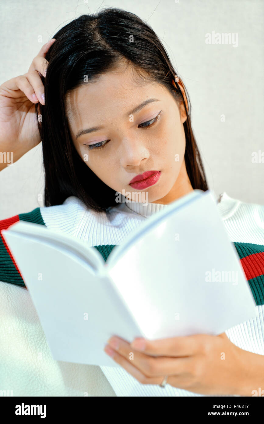 Beautiful women posing - reading a book Stock Photo - Alamy