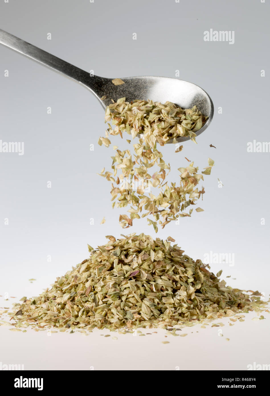 Dried Oregano Falling from Tablespoon Stock Photo - Alamy